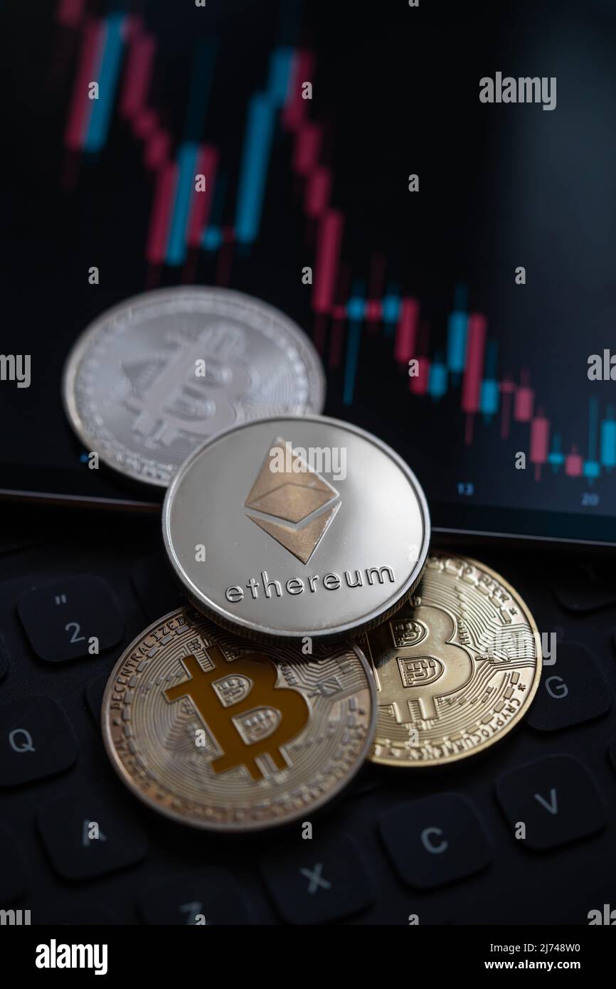 Gold Bitcoin and Ethereum cryptocurrency coins with candle stick graph ...