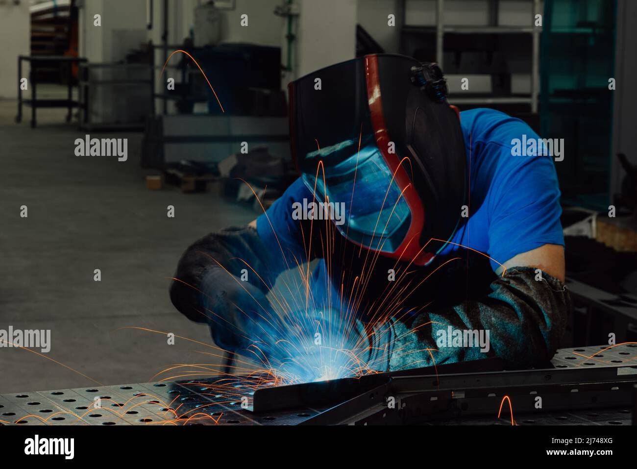 Professional Heavy Industry Welder Working Inside factory, Wears Helmet ...