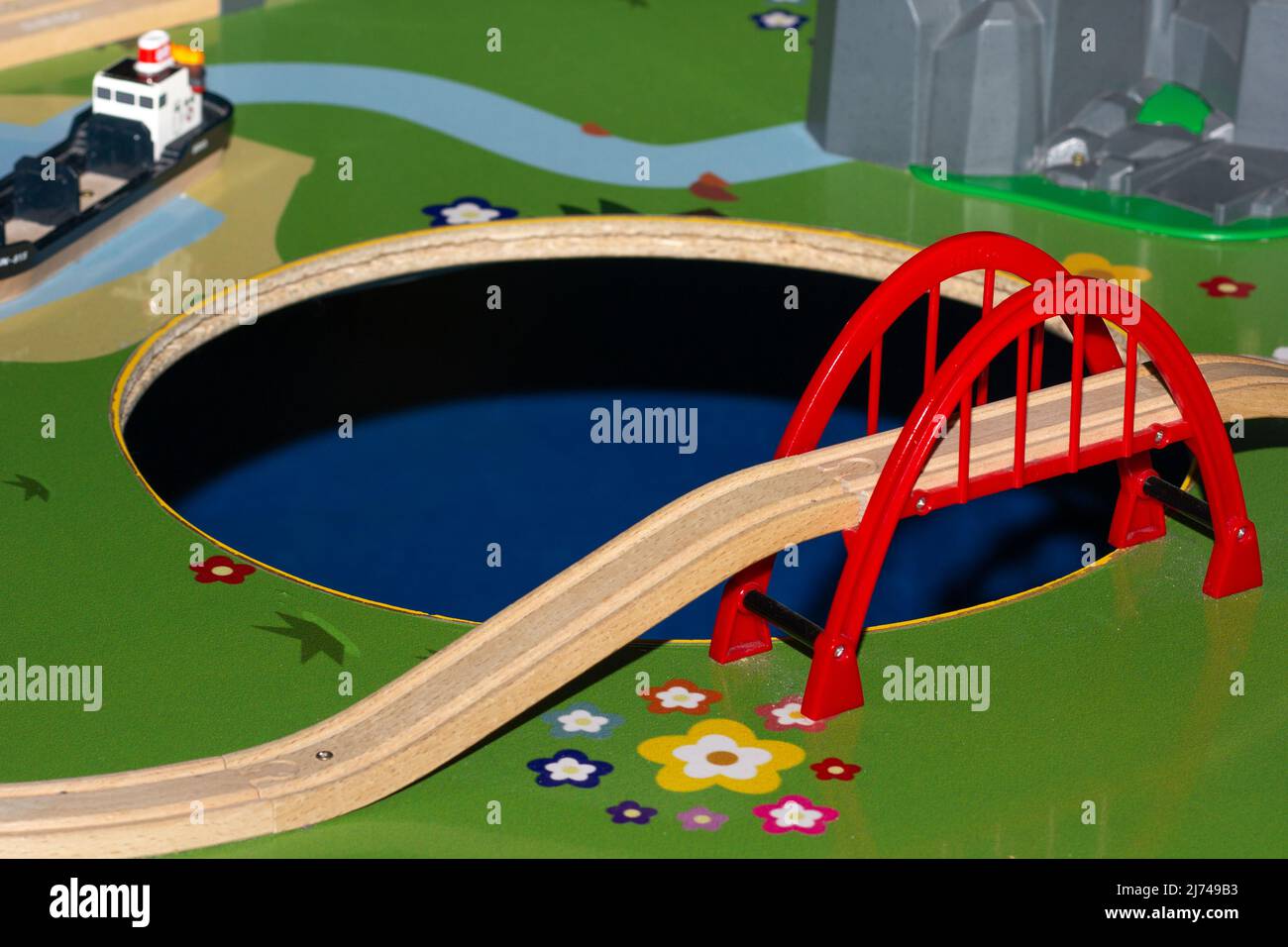 Toy bridge on playground with hole for kids Stock Photo - Alamy