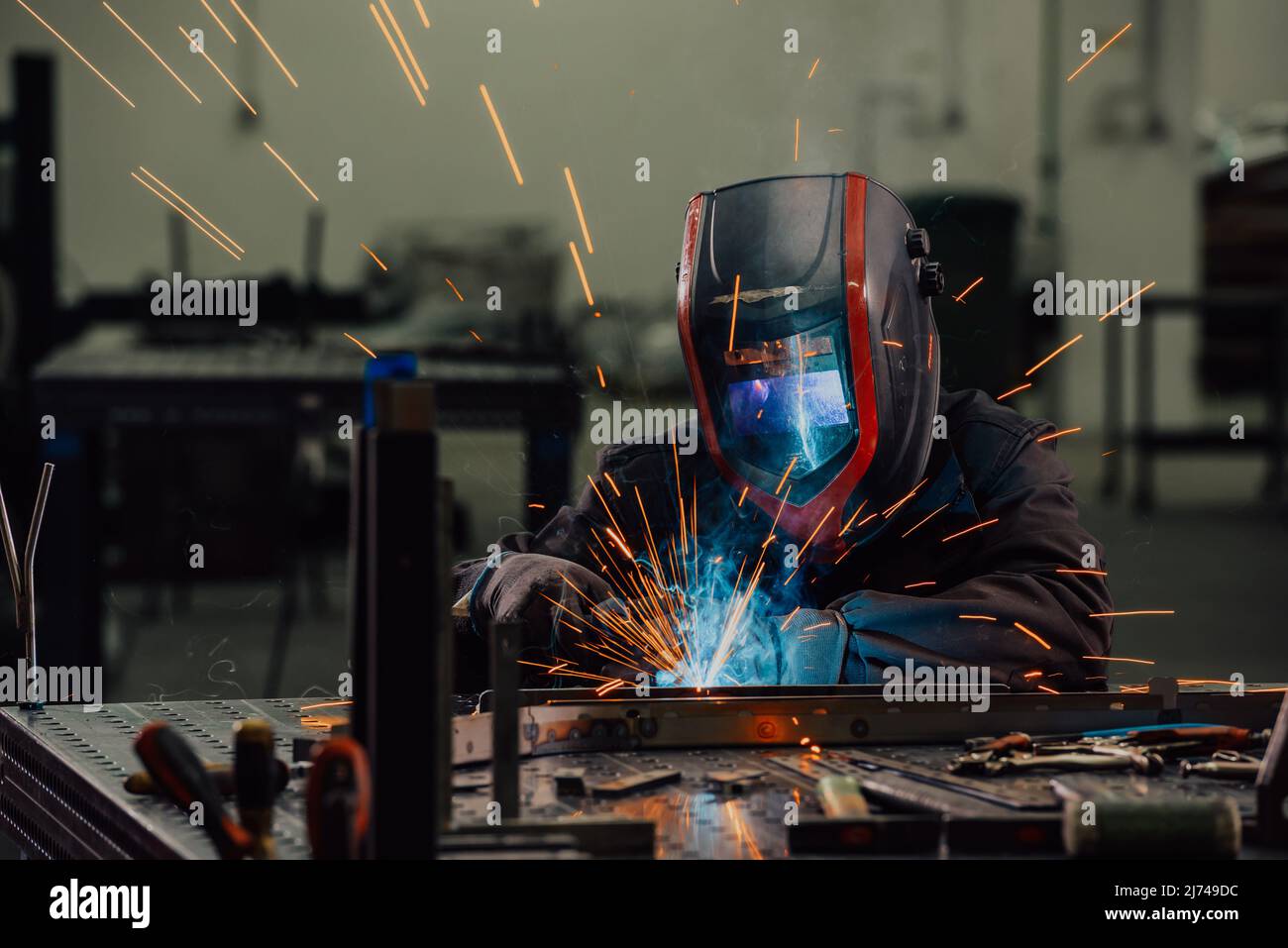 Professional Heavy Industry Welder Working Inside factory, Wears Helmet ...