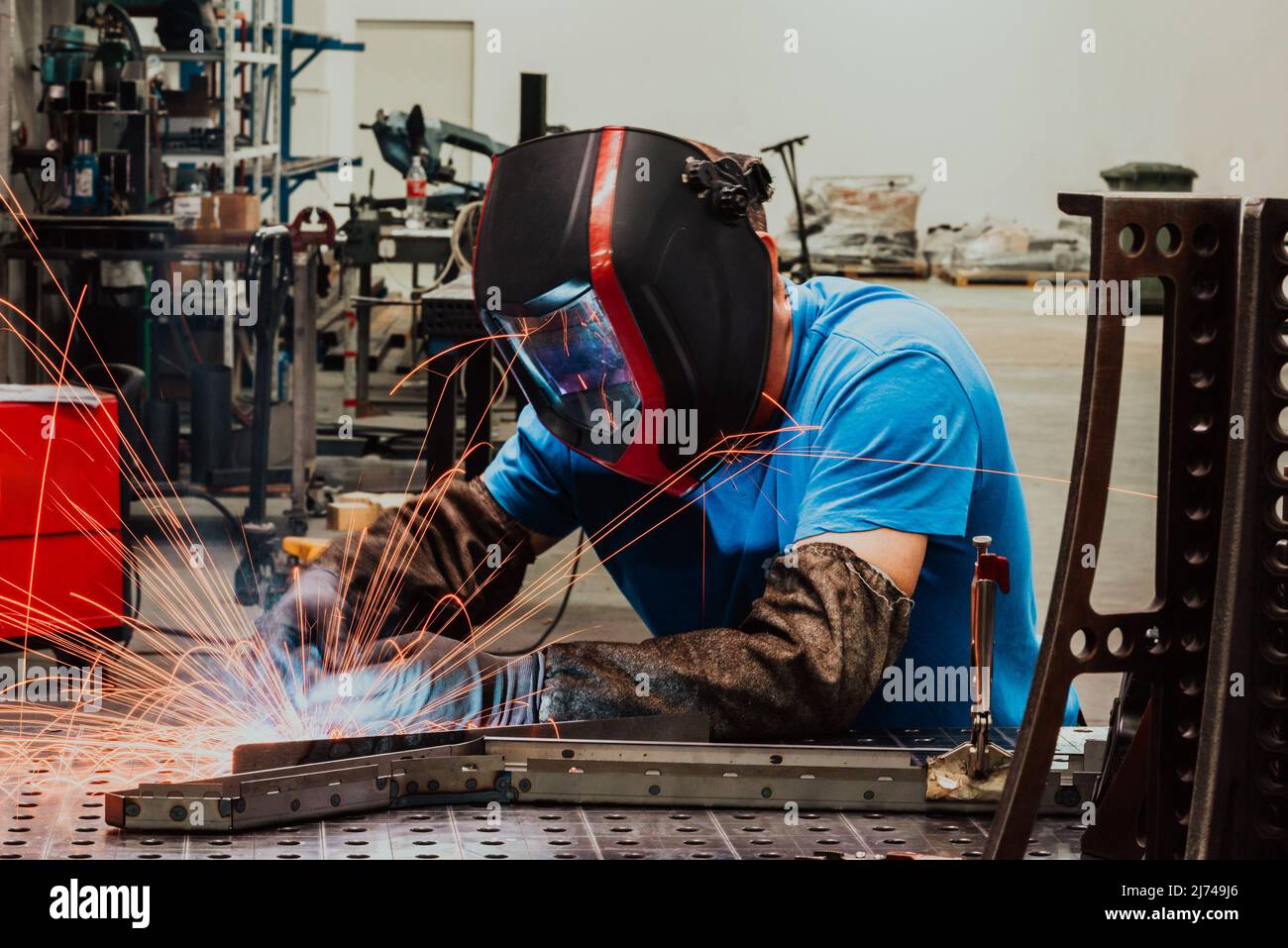 Professional Heavy Industry Welder Working Inside factory, Wears Helmet ...