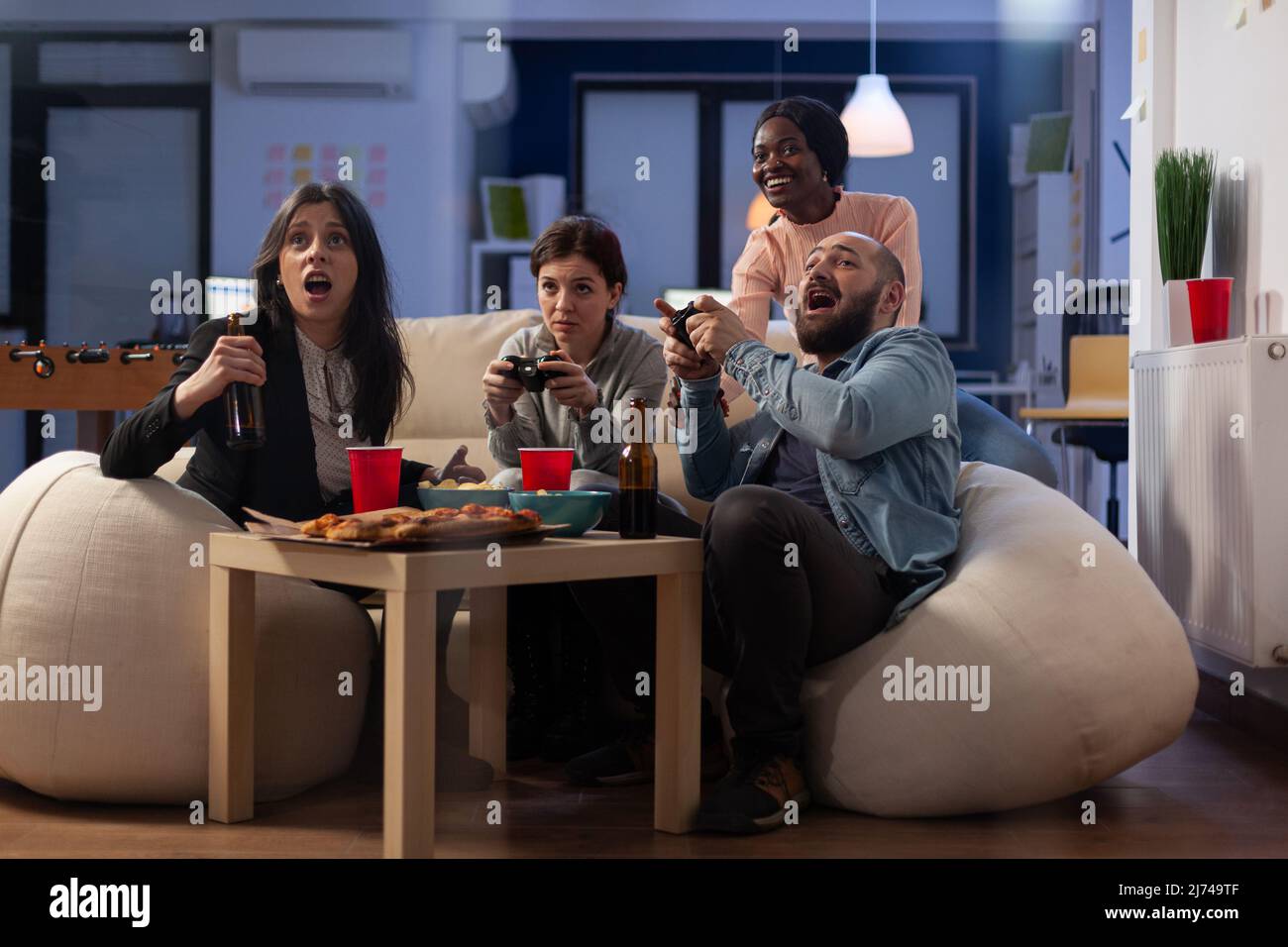 Cheerful workmates celebrating video hi-res stock photography and ...