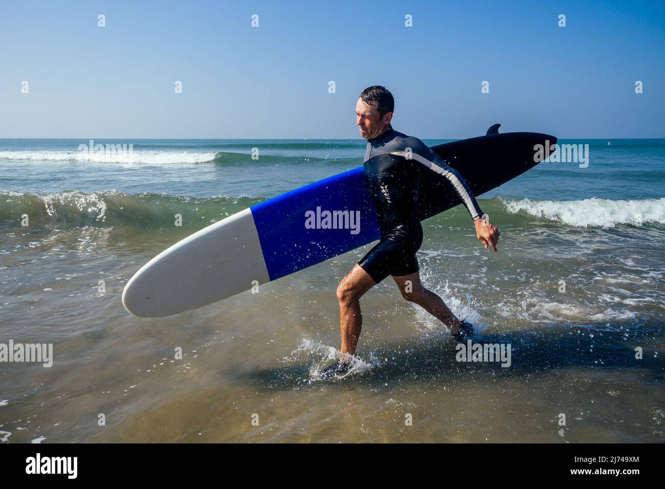 surf instructor showing how riding on big waves in Goa India Stock ...