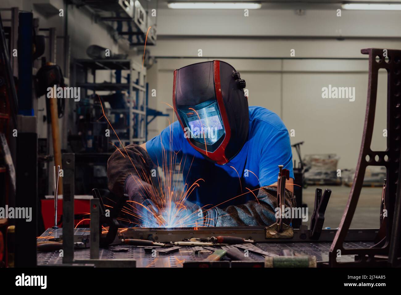 Professional Heavy Industry Welder Working Inside factory, Wears Helmet ...