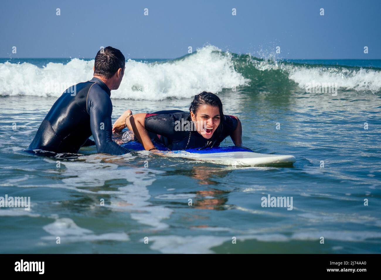 man instructor demonstrating how to paddle in the water by hands on ...