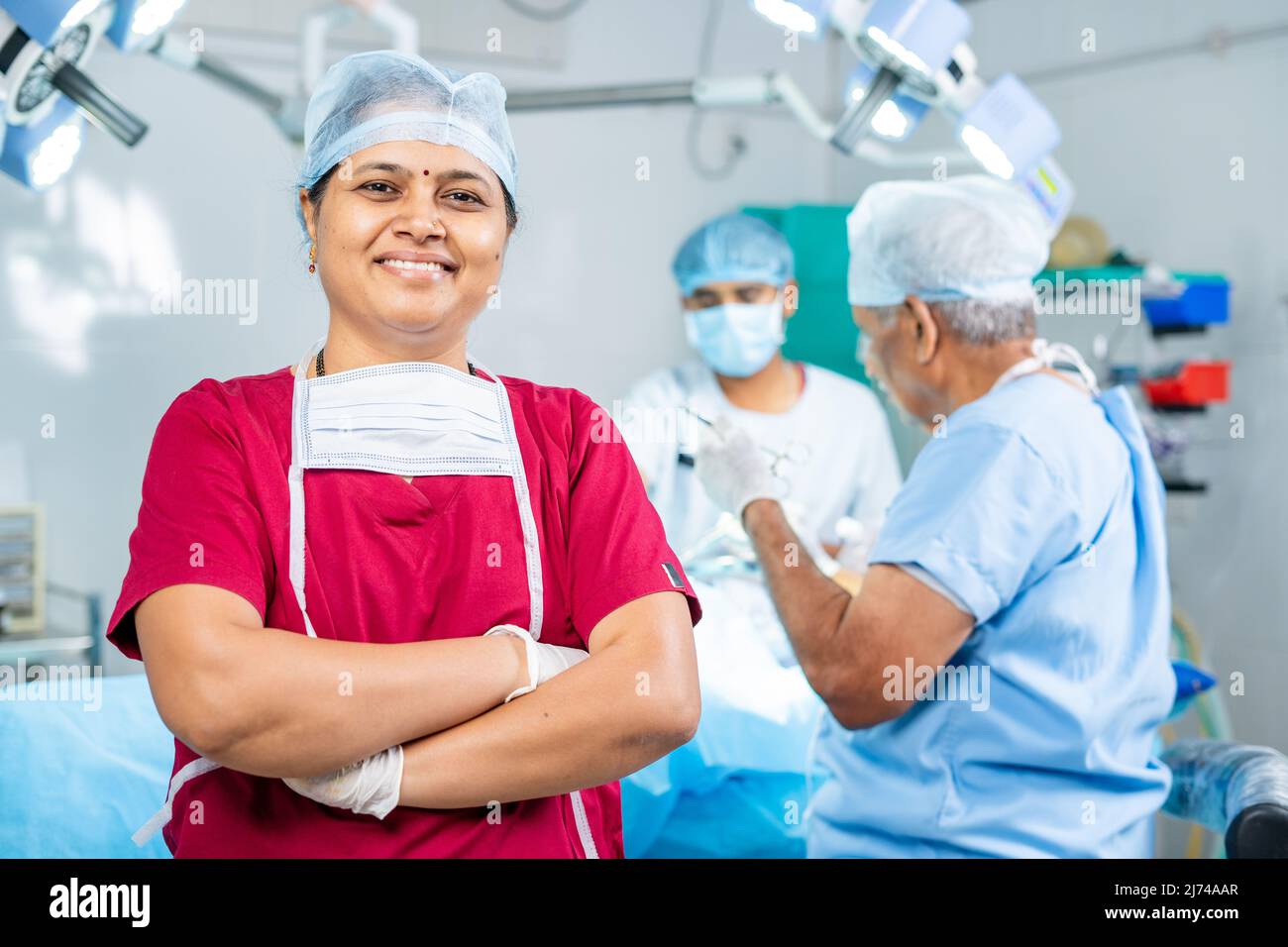 portrait shot of confident happy woman surgeon standing by looking at ...