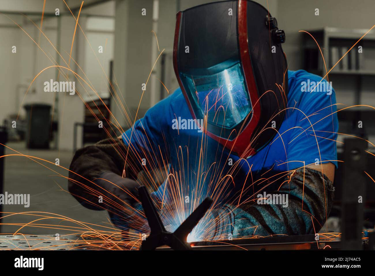 Professional Heavy Industry Welder Working Inside factory, Wears Helmet ...