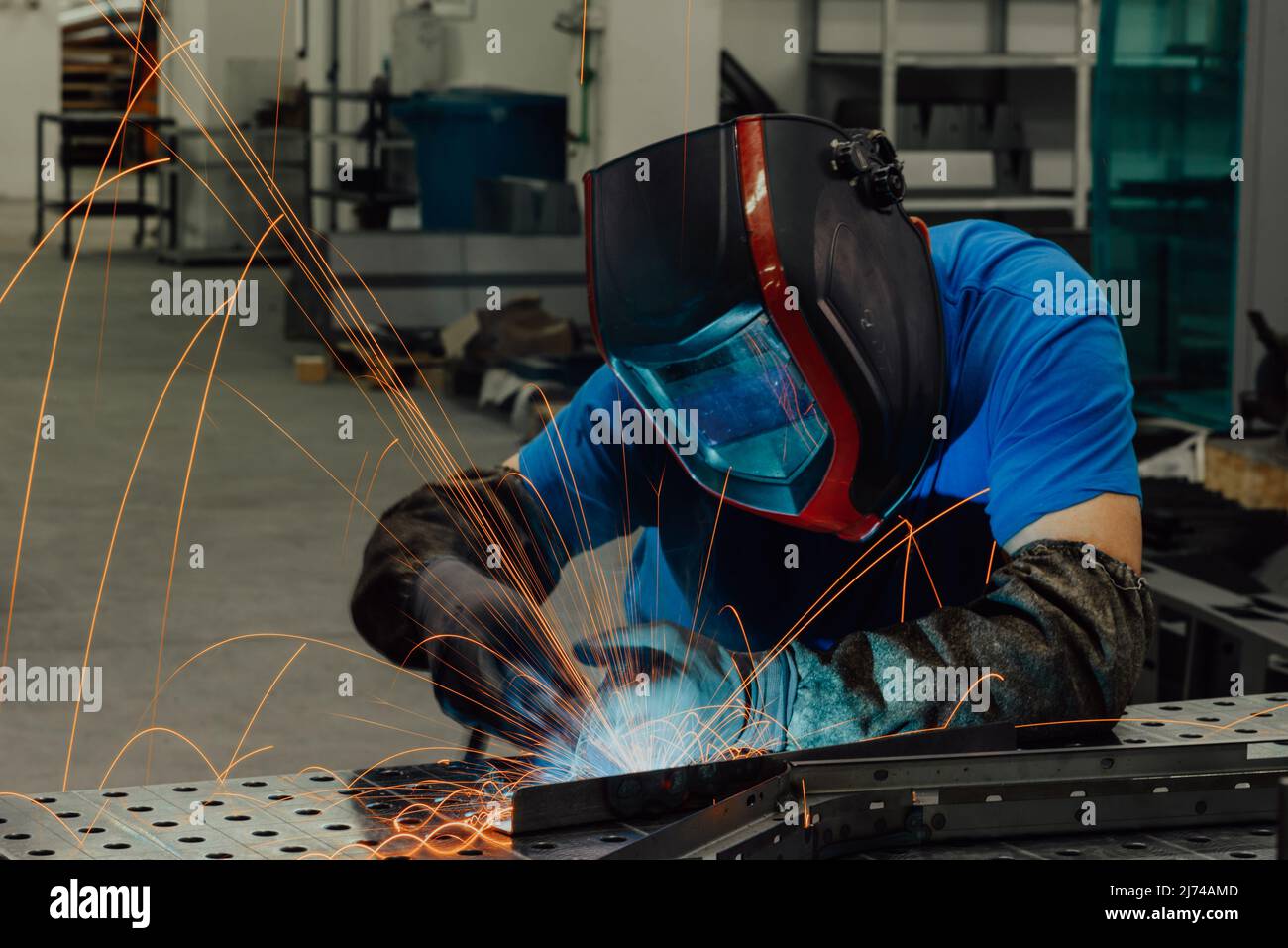 Professional Heavy Industry Welder Working Inside factory, Wears Helmet ...