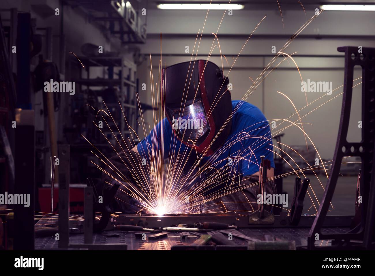 Professional Heavy Industry Welder Working Inside factory, Wears Helmet ...