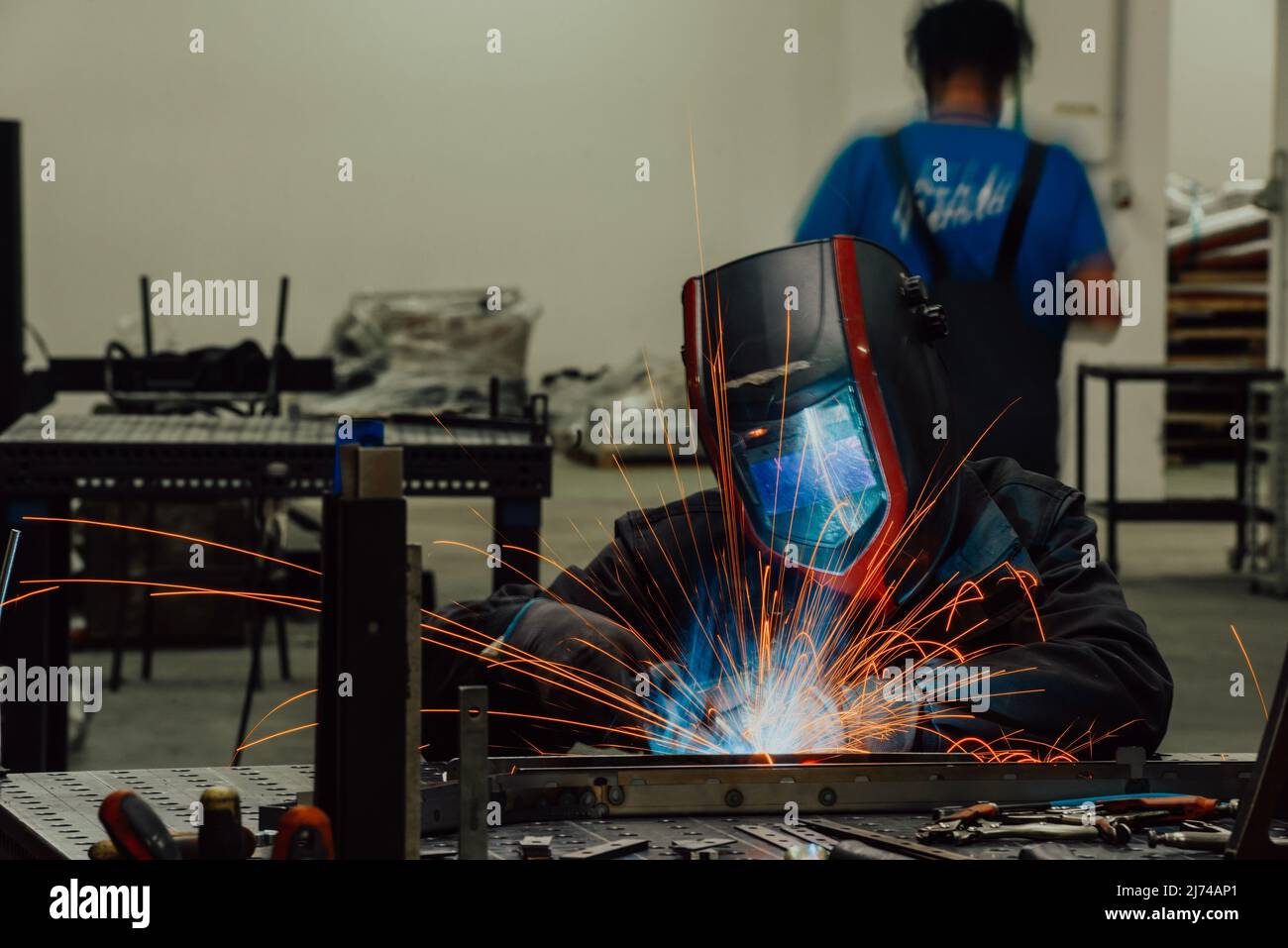 Professional Heavy Industry Welder Working Inside factory, Wears Helmet ...