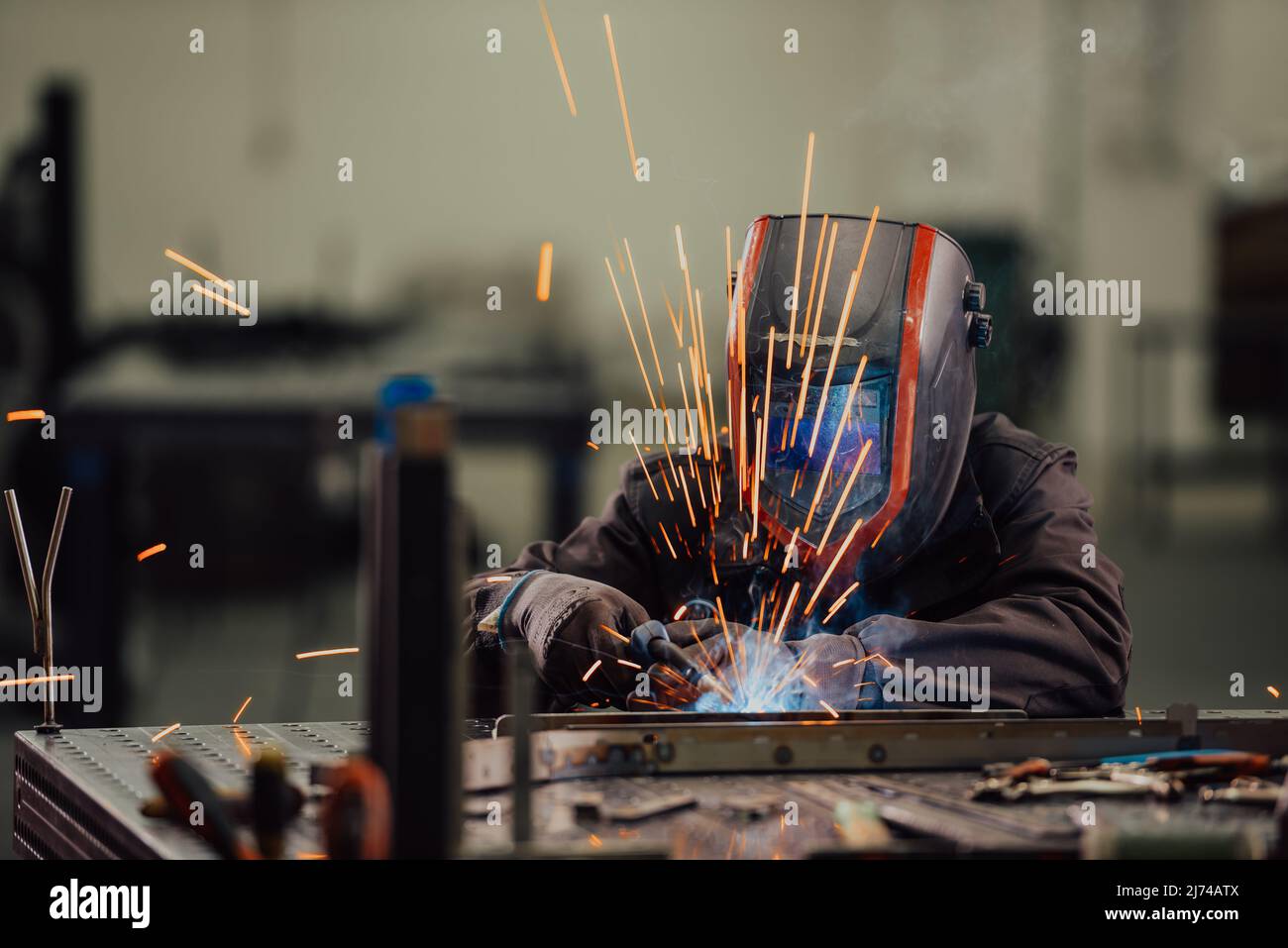 Professional Heavy Industry Welder Working Inside factory, Wears Helmet ...