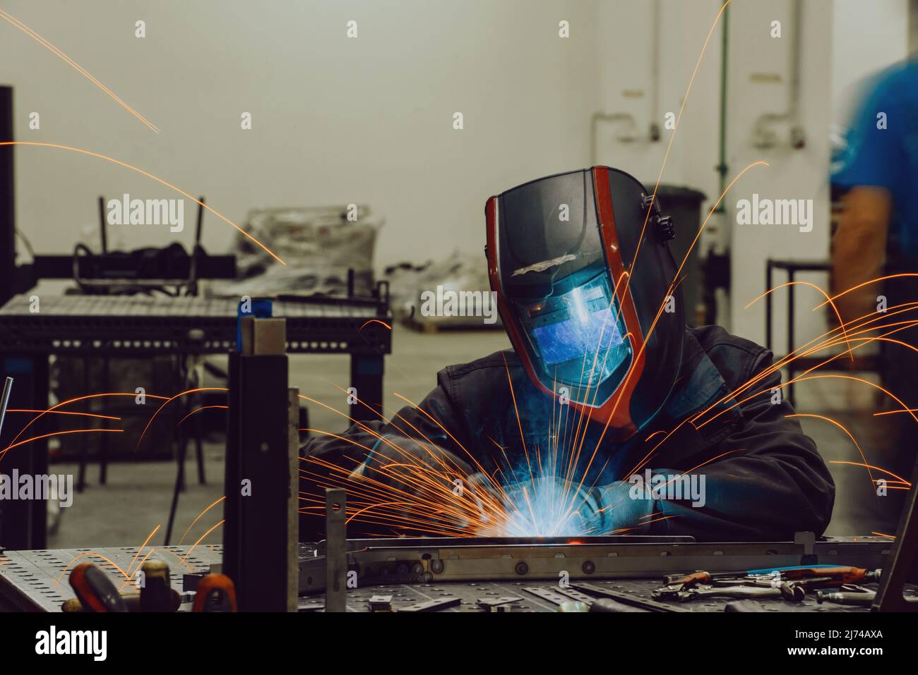 Professional Heavy Industry Welder Working Inside factory, Wears Helmet ...