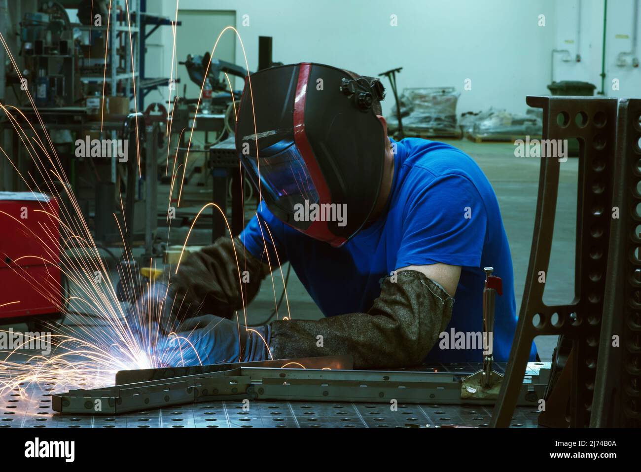 Professional Heavy Industry Welder Working Inside factory, Wears Helmet ...