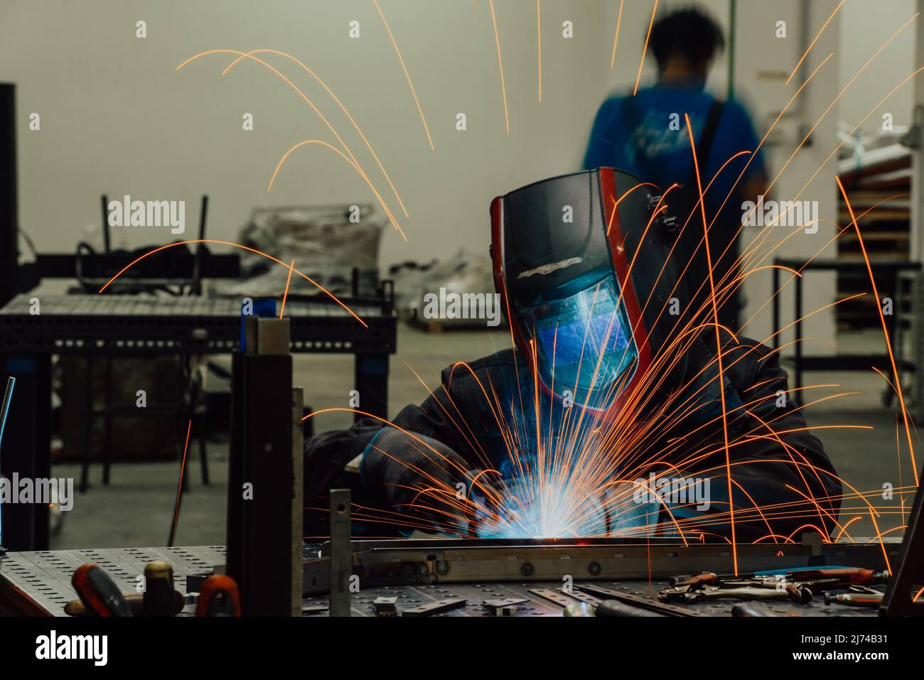 Professional Heavy Industry Welder Working Inside factory, Wears Helmet ...