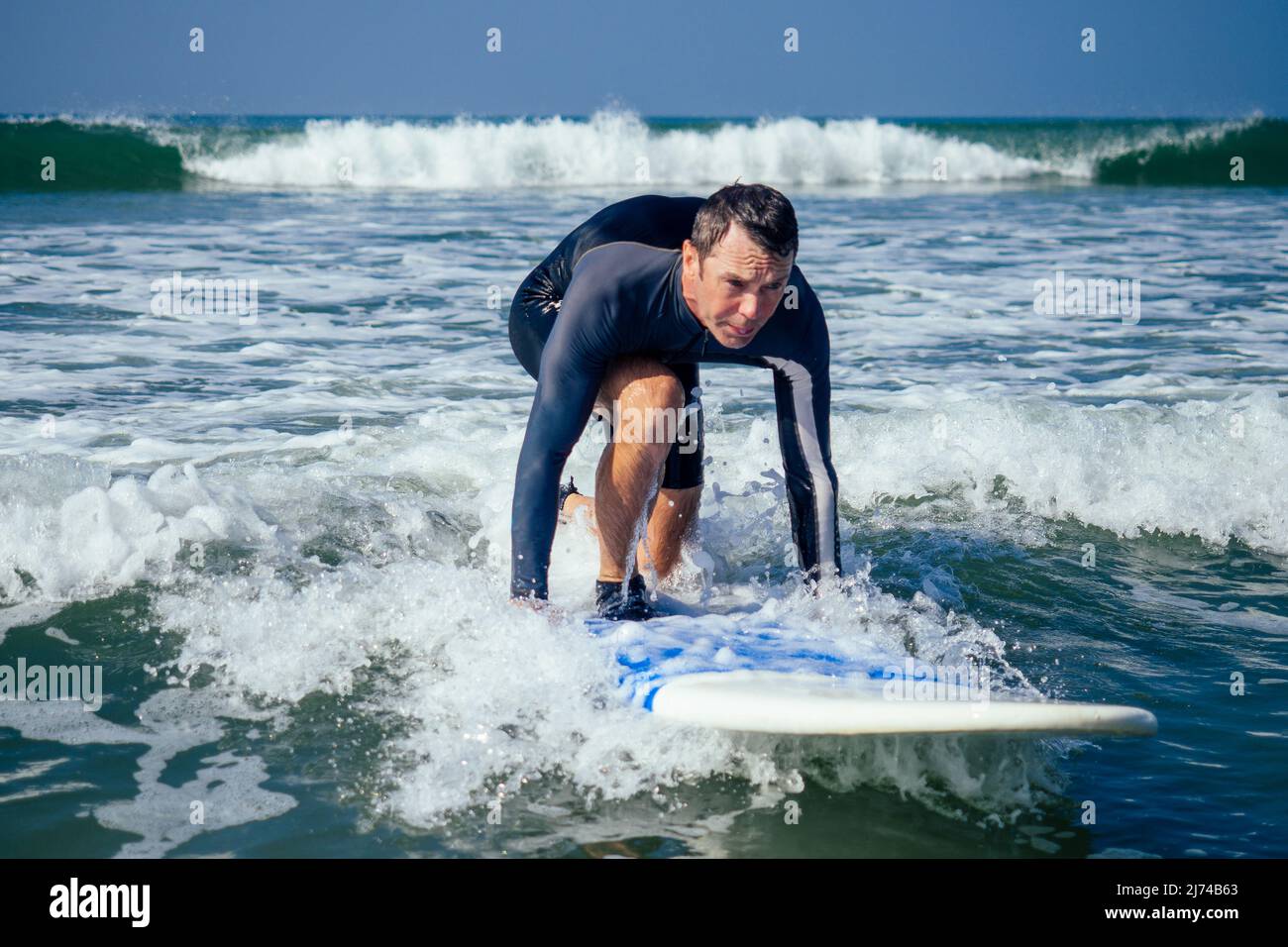 surf instructor showing how riding on big waves in Goa India Stock ...