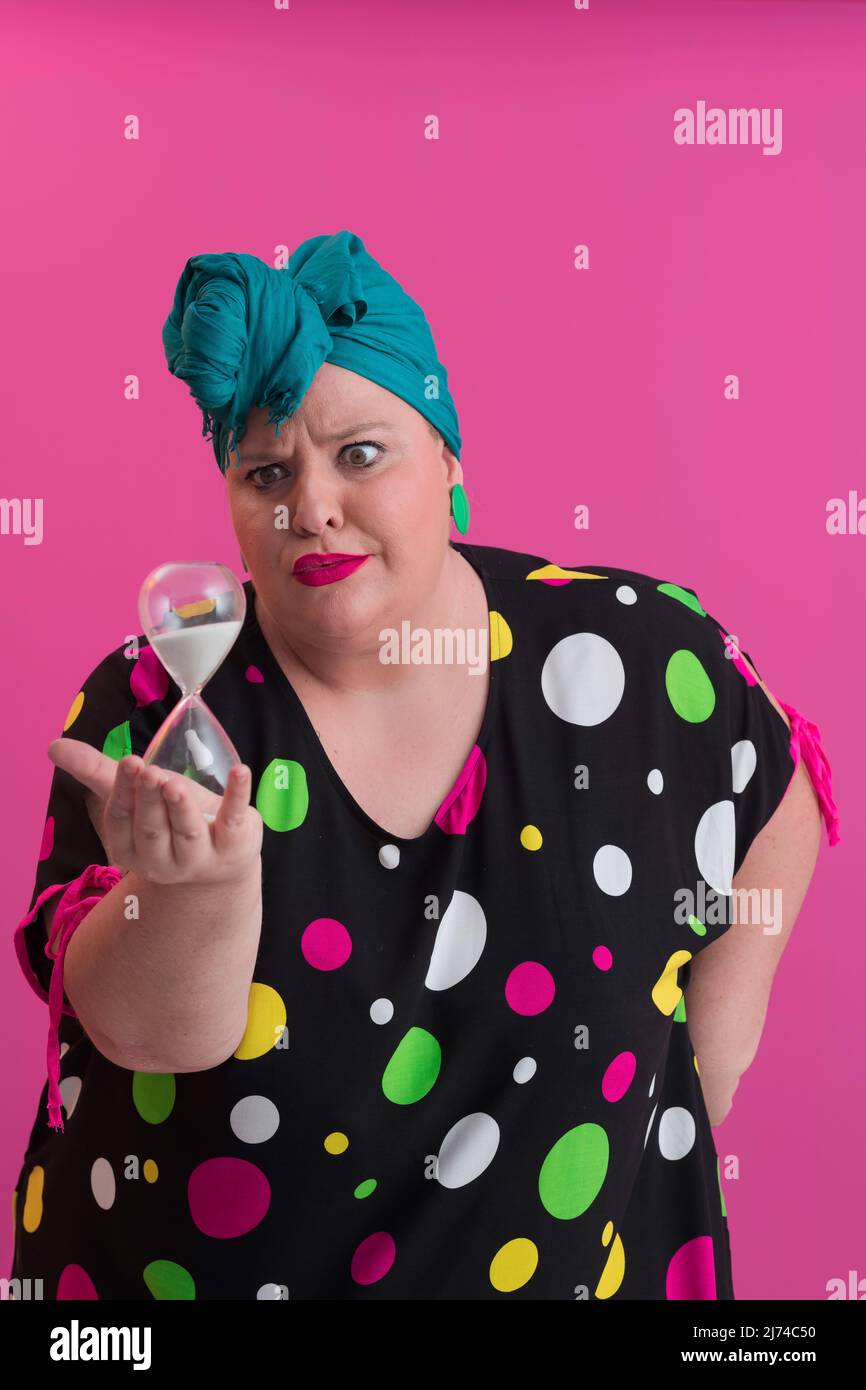 Portrait of plus size young lady smiling hands holds sand clock ...