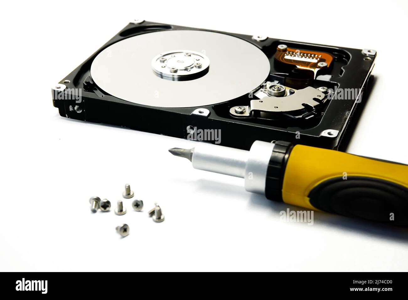 Open hard drive and screwdriver isolated on white background closeup ...