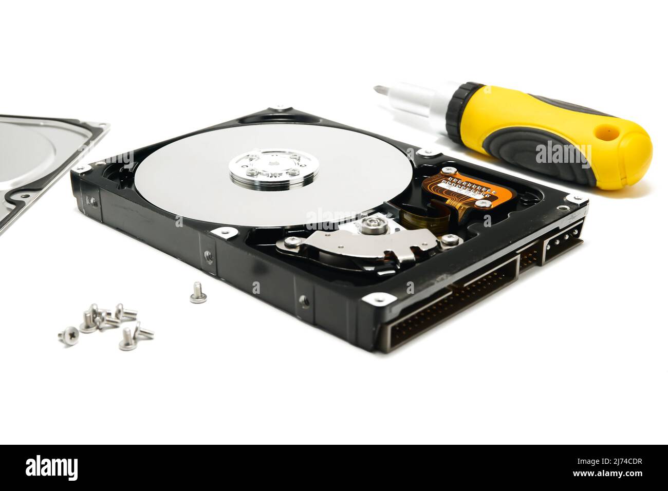 Open hard drive and screwdriver isolated on white background closeup ...