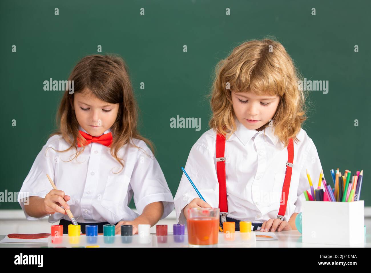 Kids pupils learning painting. Portrait school kids doing art homework ...