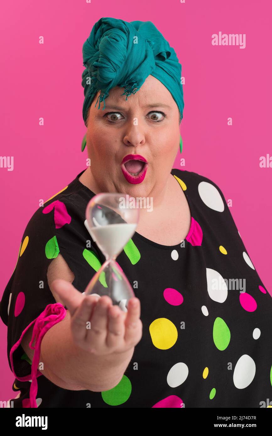 Portrait of plus size young lady smiling hands holds sand clock ...