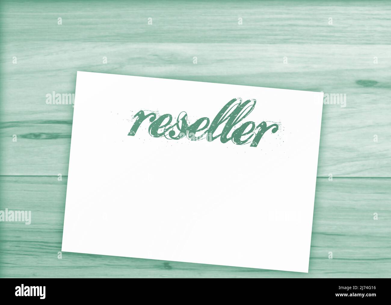 RESELLER Word on page and paper dollar signs around on wooden table ...