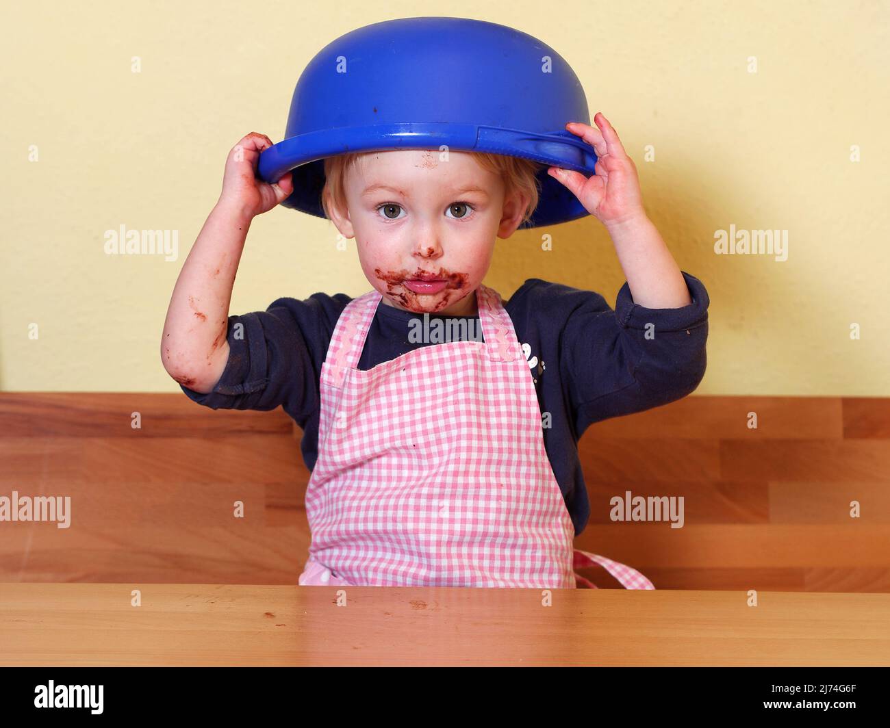 after licking the mixing bowl girl is holding the mixing bowl on her ...