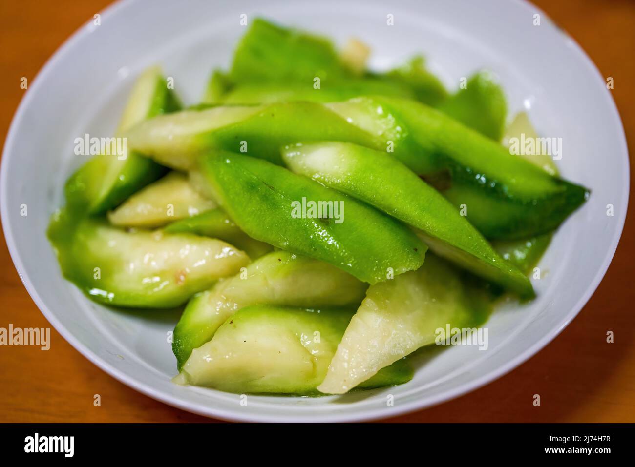 A plate of light and fresh Chinese home cooking, stir-fried loofah ...