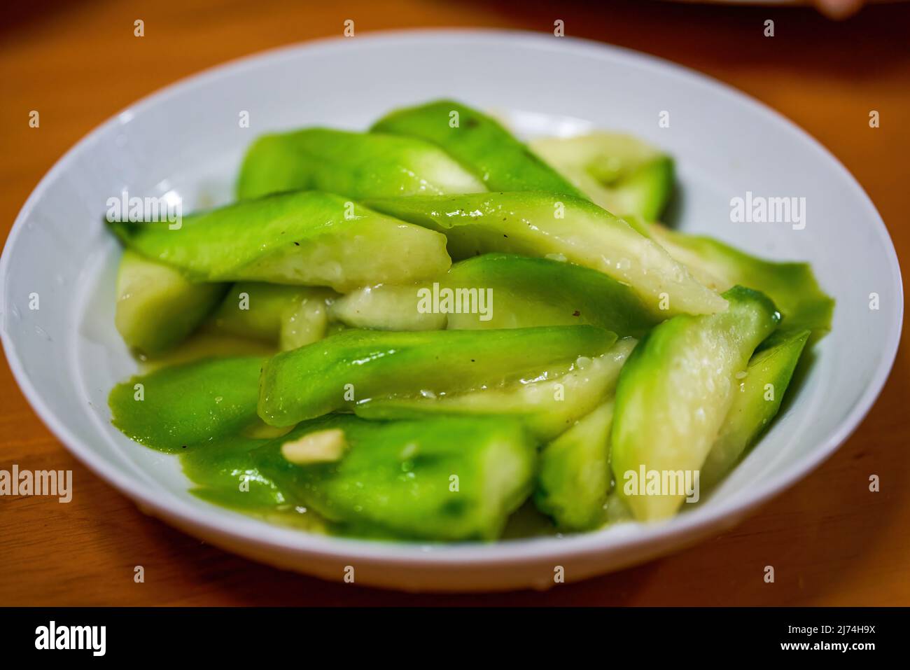 A plate of light and fresh Chinese home cooking, stir-fried loofah ...