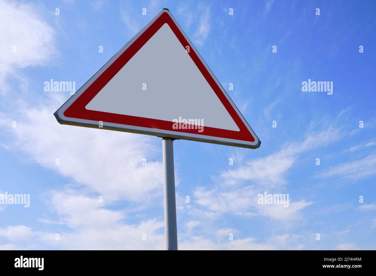 Traffic warning sign background clouds and blue sky Stock Photo - Alamy