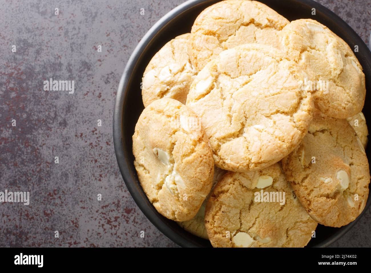 White chocolate biscuit cookies and macadamia nuts in the plate on the ...