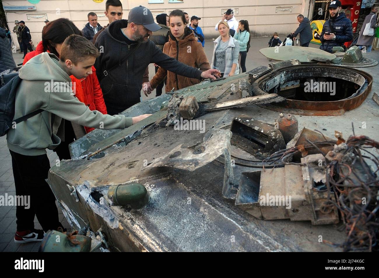 VINNYTSIA, UKRAINE - MAY 5, 2022 - People look at a Russian tank and an ...
