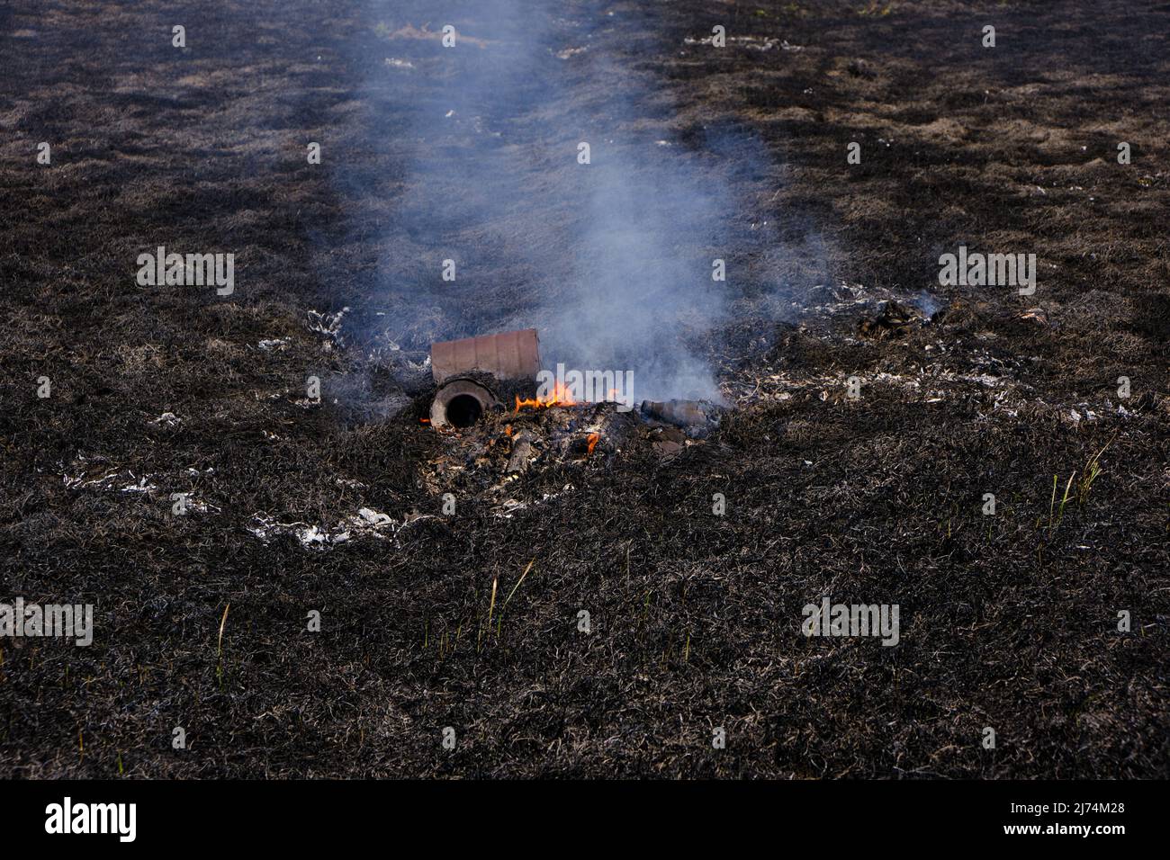 Burning garbage after strong fire Stock Photo - Alamy