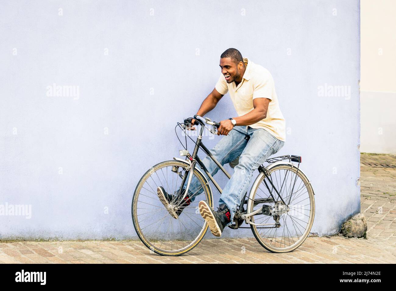 African american guy having fun with vintage bicycle - Free time with ...