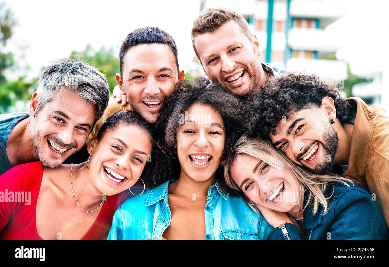 Multi generation guys and girls taking selfie outdoors with backlight ...