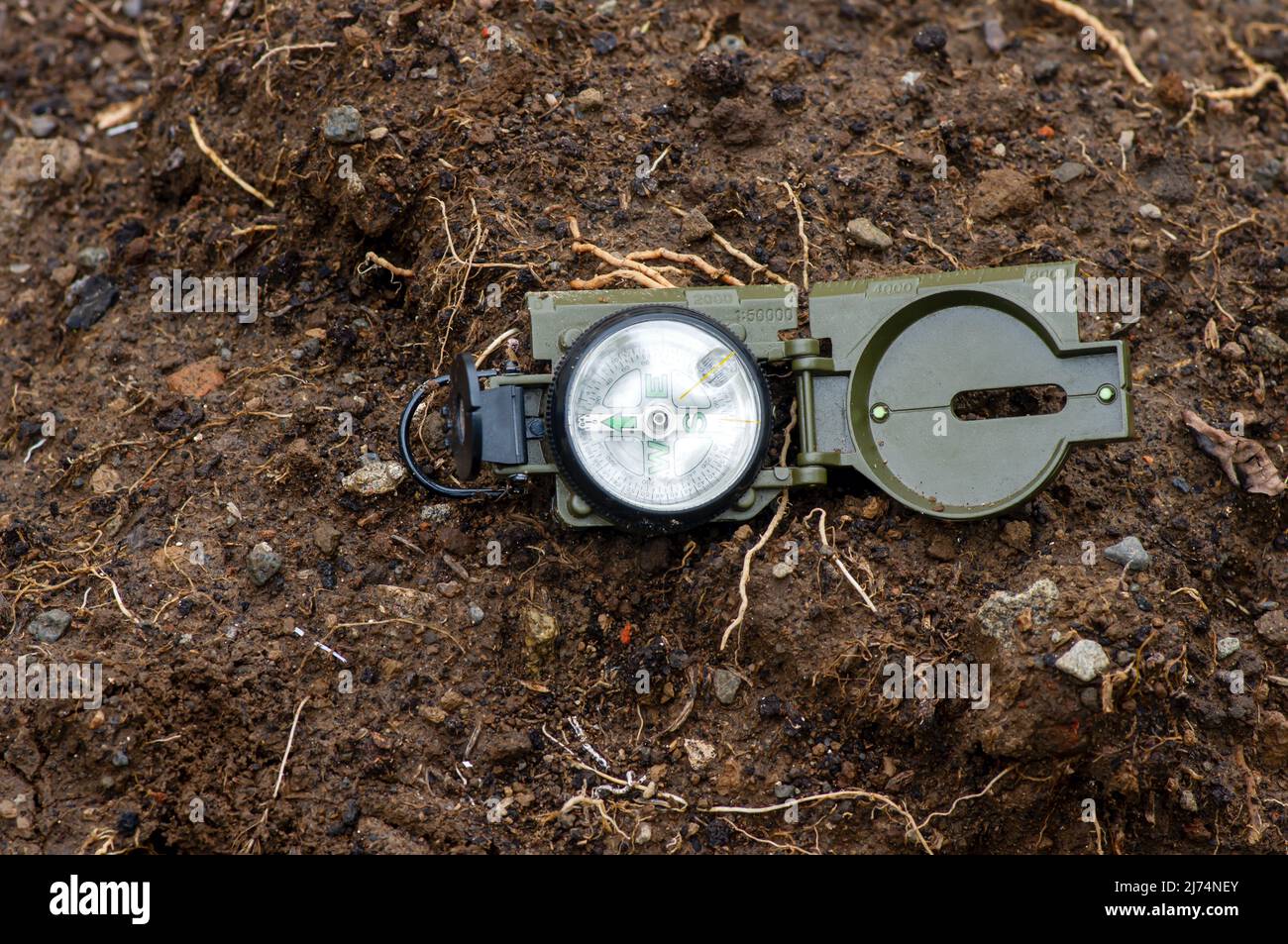 An green army magnetic compass on the ground Stock Photo - Alamy