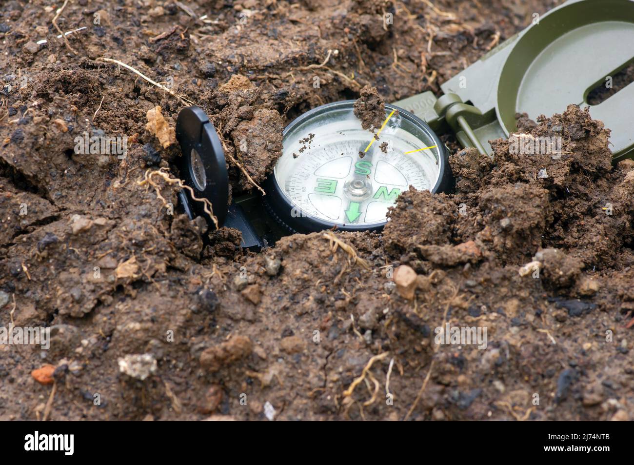 An green army magnetic compass on the ground Stock Photo - Alamy