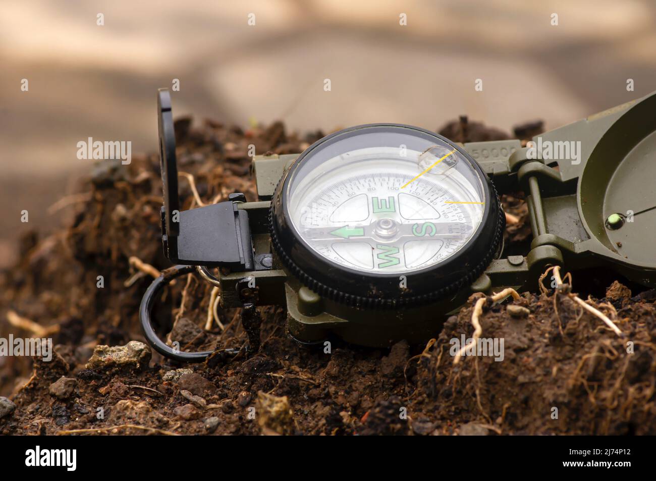 An green army magnetic compass on the ground Stock Photo - Alamy