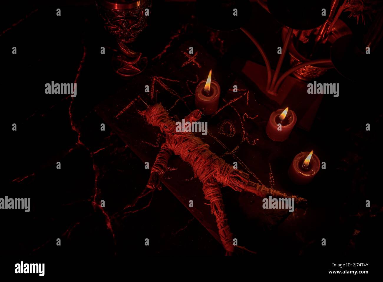 Voodoo Magic concept. Voodoo doll studded with needles with pierced rag ...