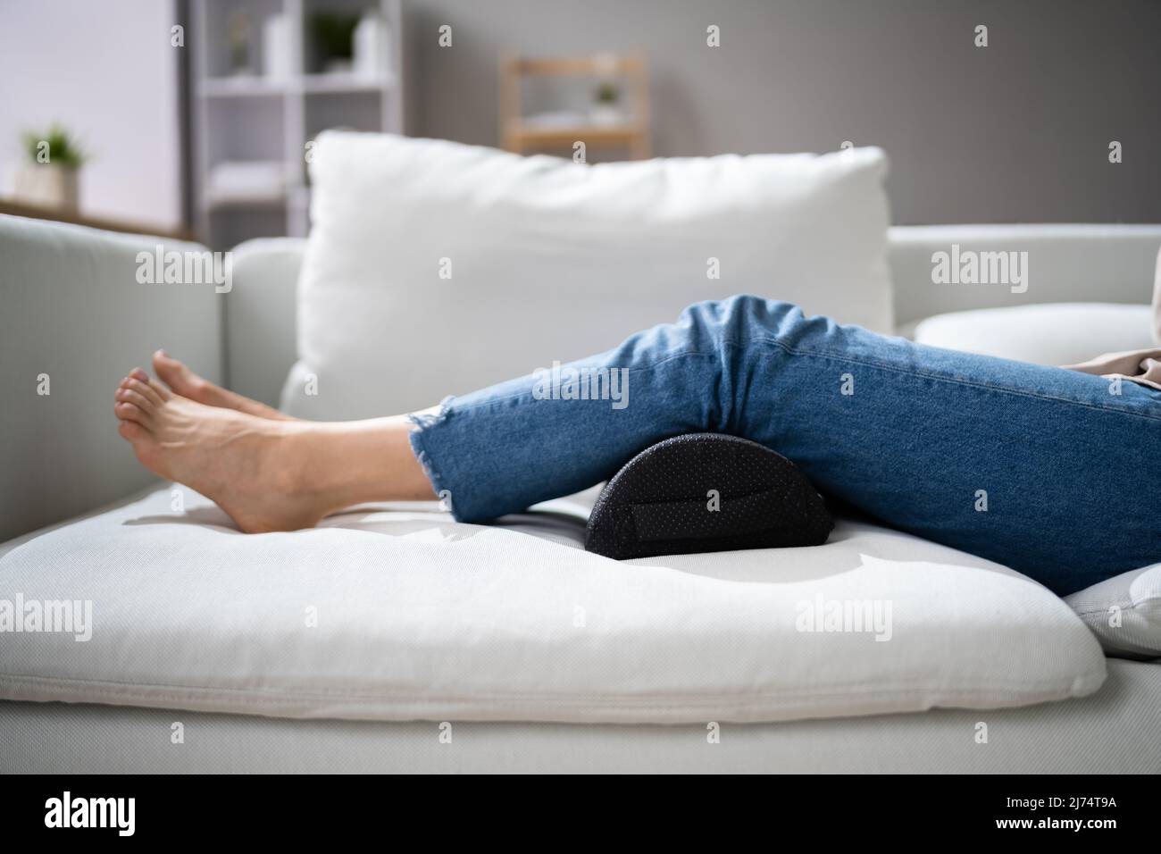 Woman Using Footrest To Reduce Back Strain And Feet Fatigue Stock Photo ...