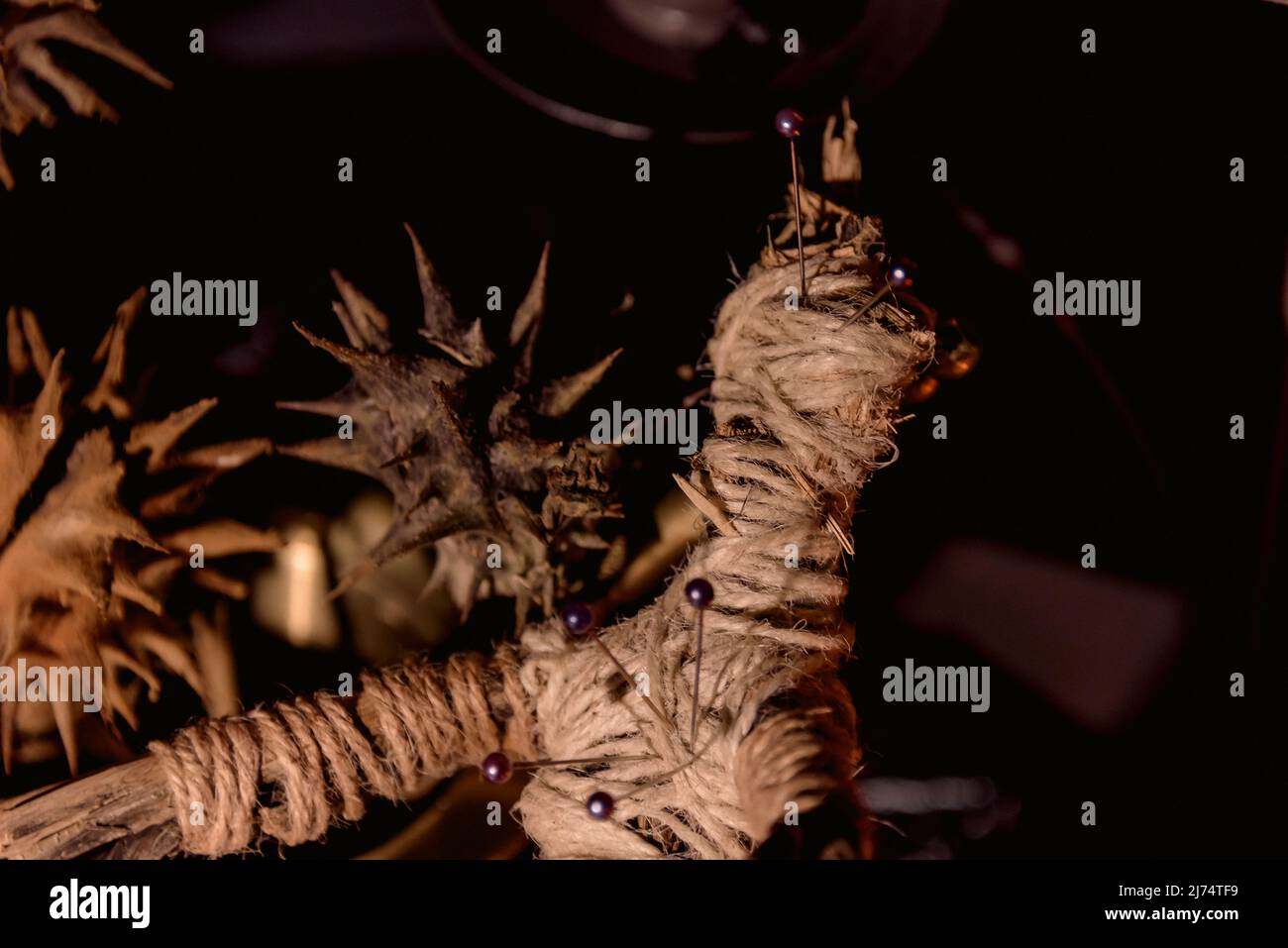 Voodoo Magic concept. Voodoo doll studded with needles with pierced rag ...