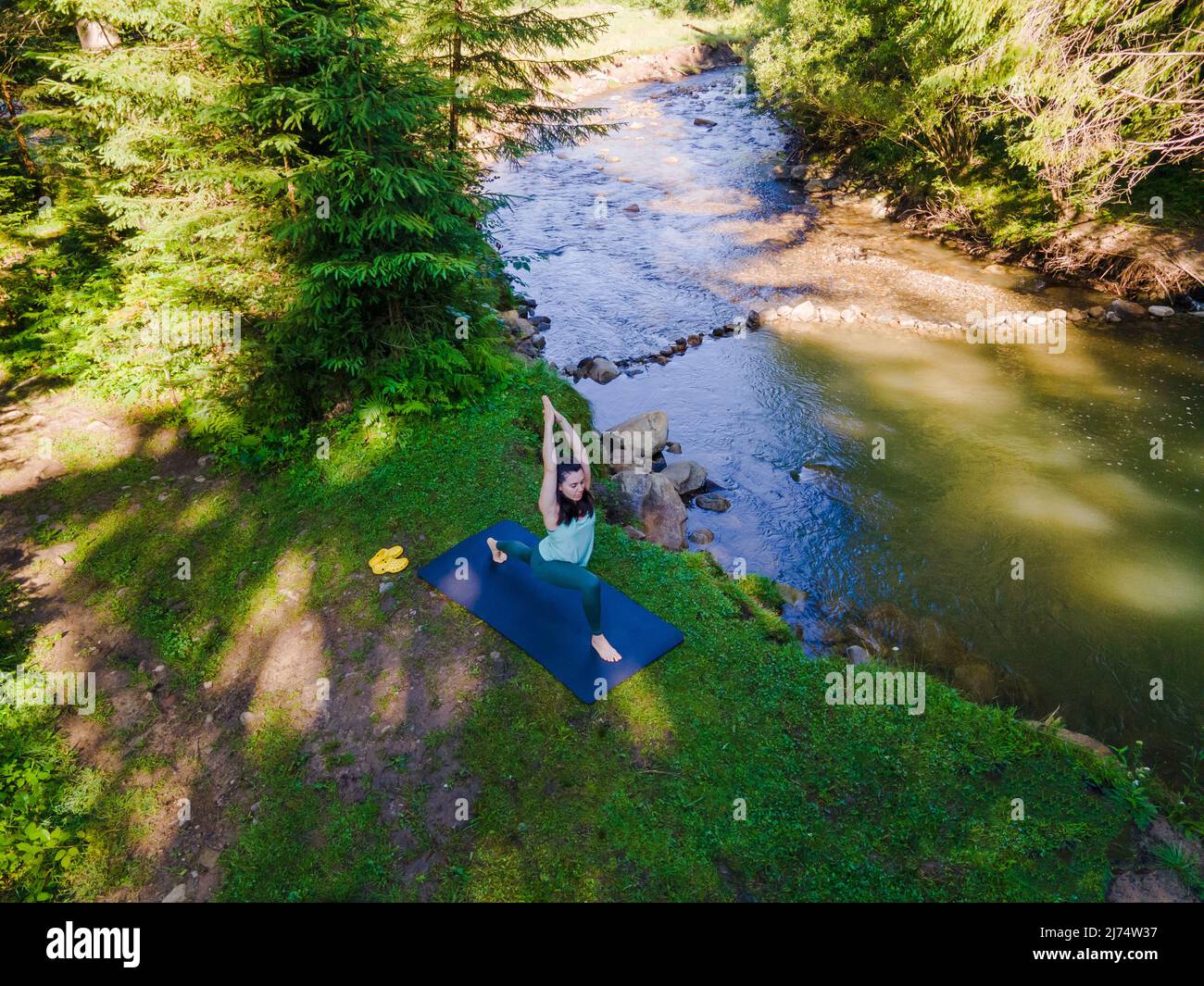 woman do yoga at river beach summertime Stock Photo - Alamy