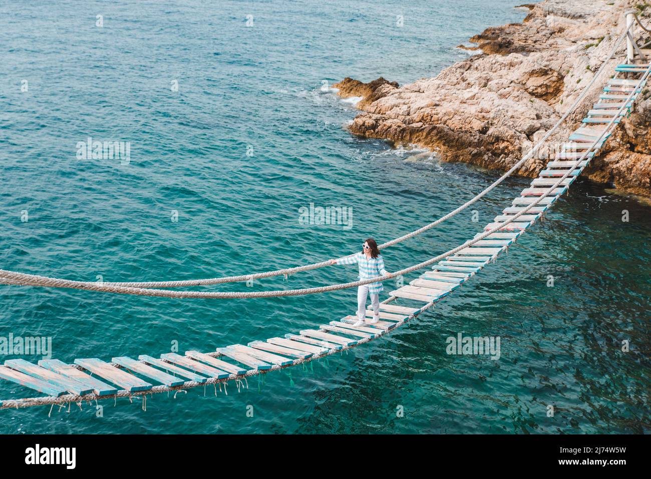 Young woman crossing bridge above hi-res stock photography and images ...