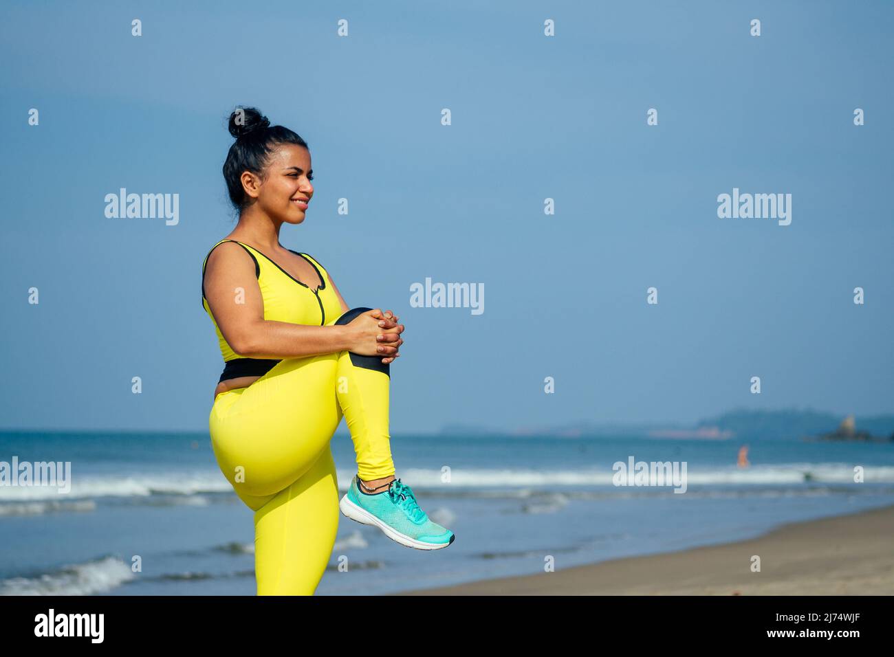 Female runner jogging during outdoor workout on beach. Beautiful fit ...
