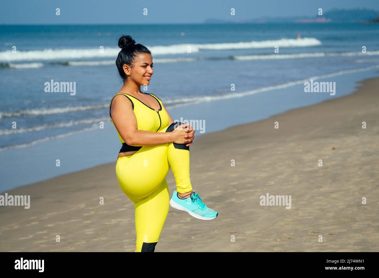 Female runner jogging during outdoor workout on beach. Beautiful fit ...