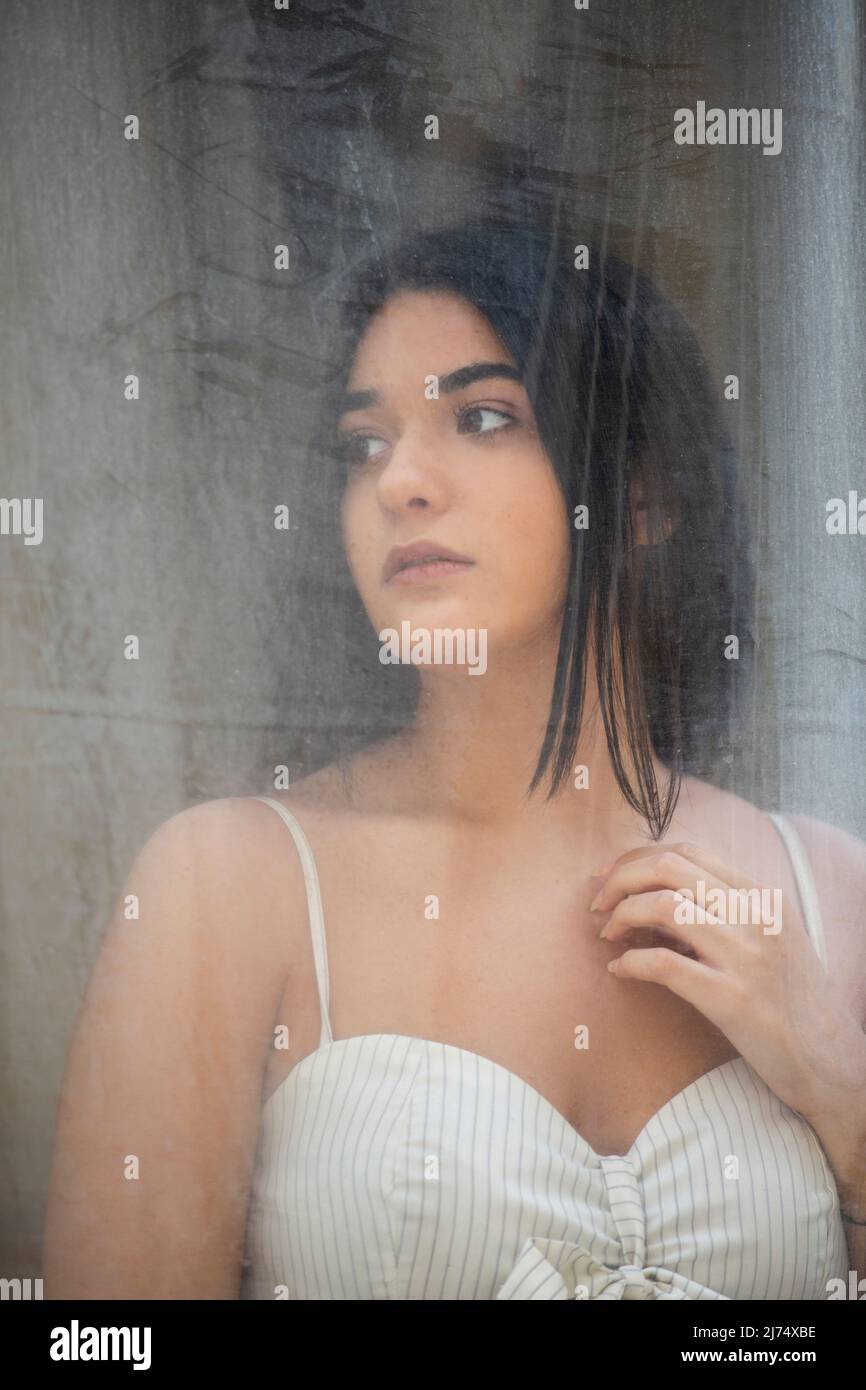Woman standing behind dusty window Stock Photo - Alamy