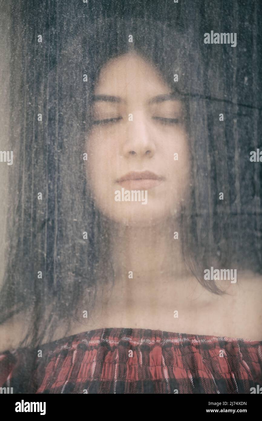 Woman standing behind dusty window Stock Photo - Alamy