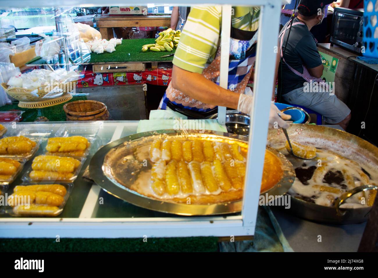 Thai chef and merchant people cooking sweet cuisine or dessert food for ...