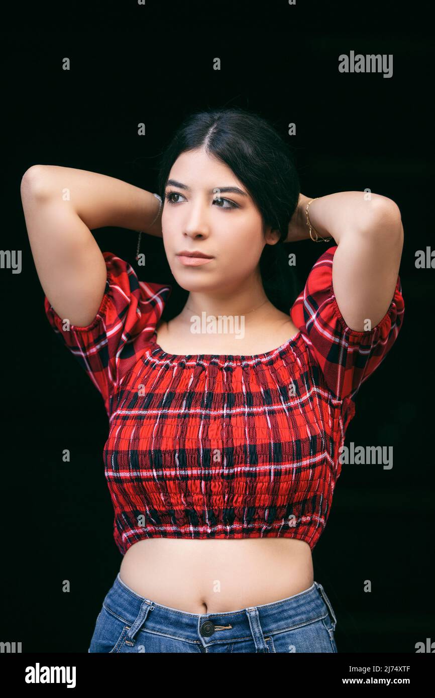 Beautiful woman hands in hair looking away Stock Photo - Alamy