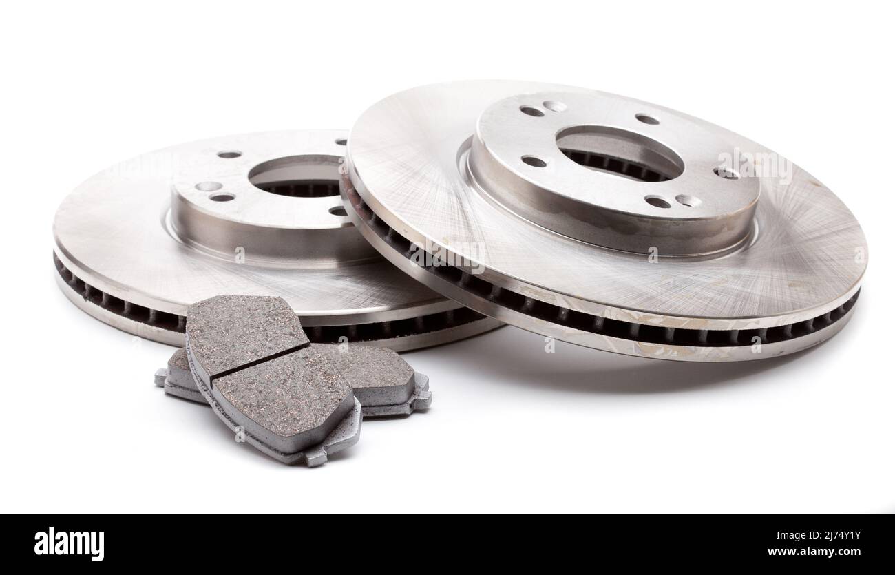 Studio shot of two front brake disks and pads for a modern car isolated ...