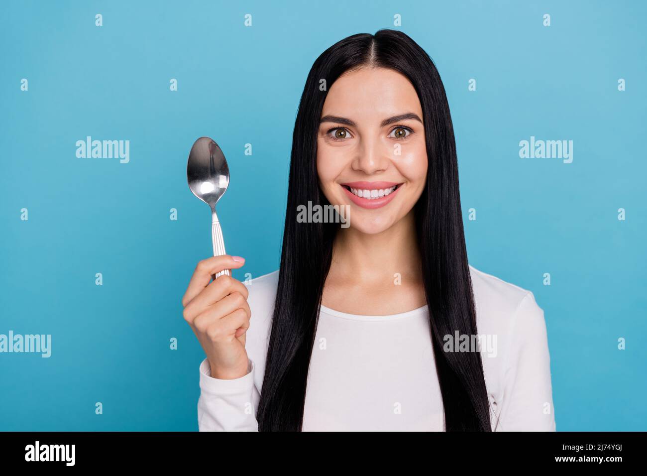 Photo of young cute brunette lady hold spoon wear white cloth isolated ...